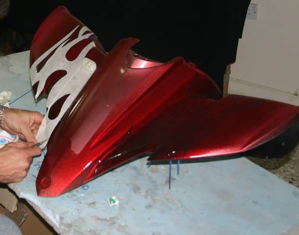 Use of adhesives in personalized painting on vehicles