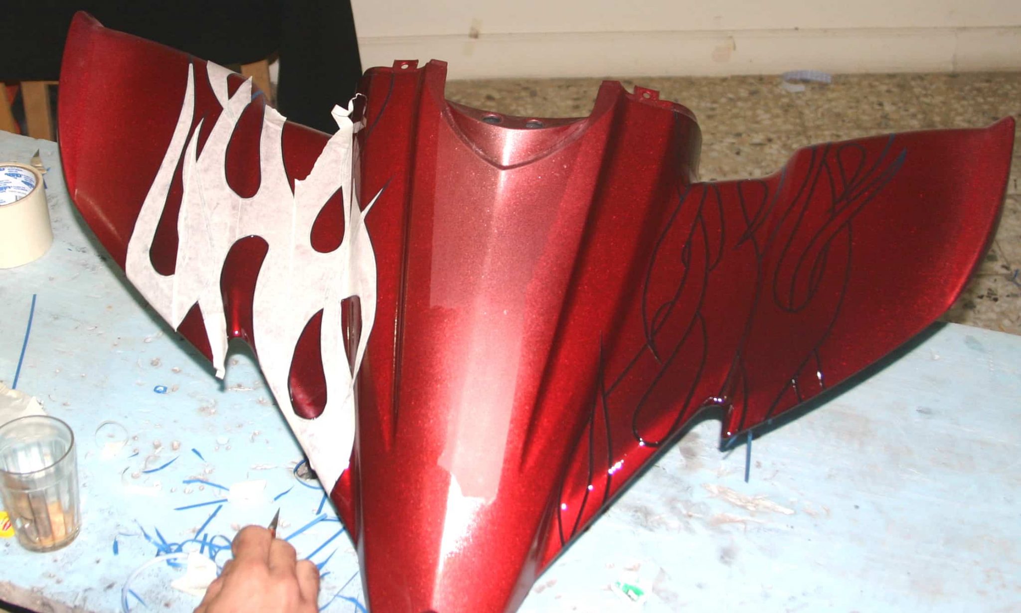 Use of adhesives in personalized painting on vehicles